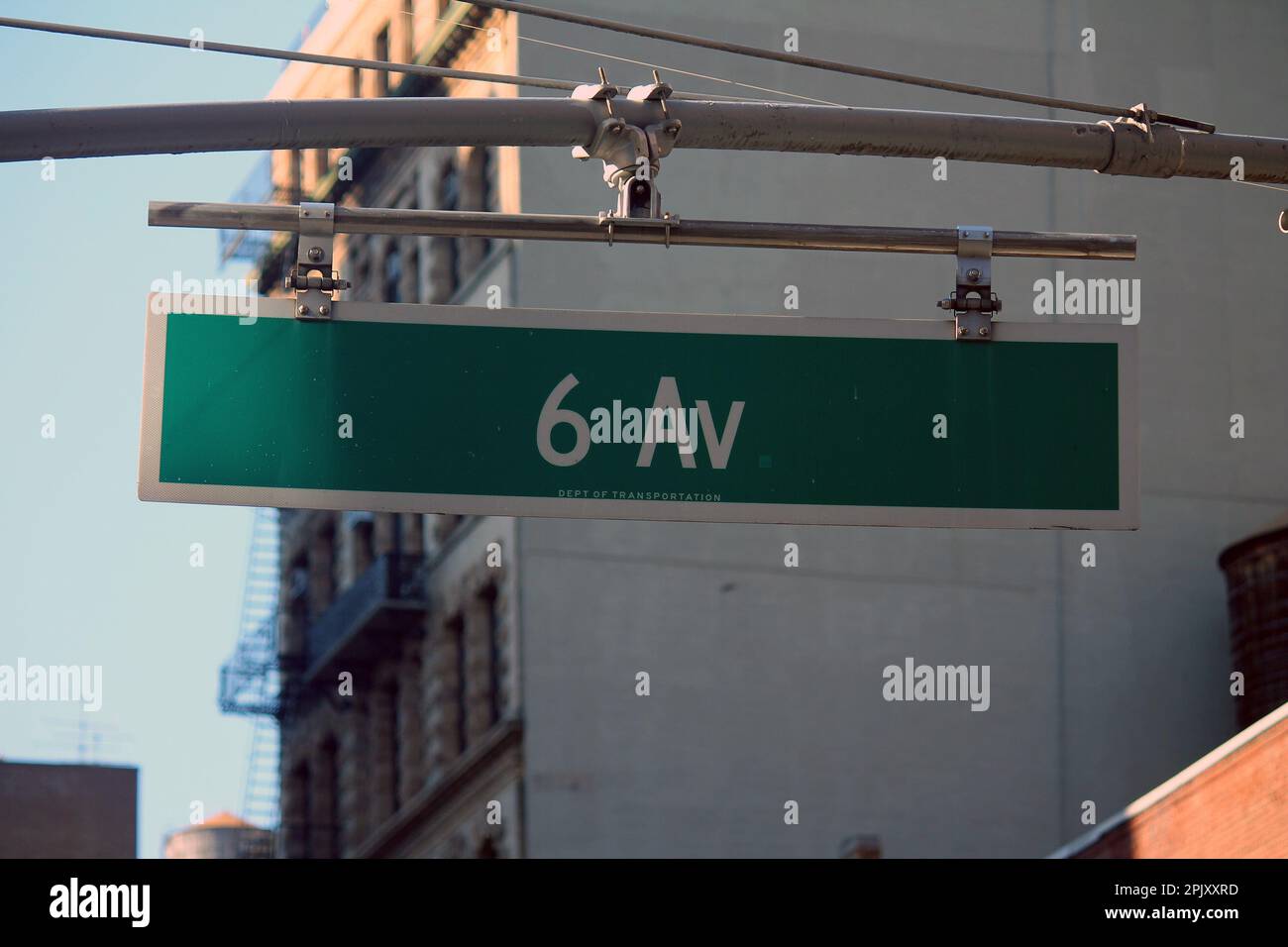 Green big 6th Avenue sign hanging on a arch pole in the streets of ...