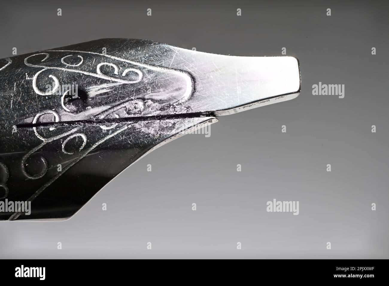 Extreme partial view detail close up of a metal fountain pen nib tip ...