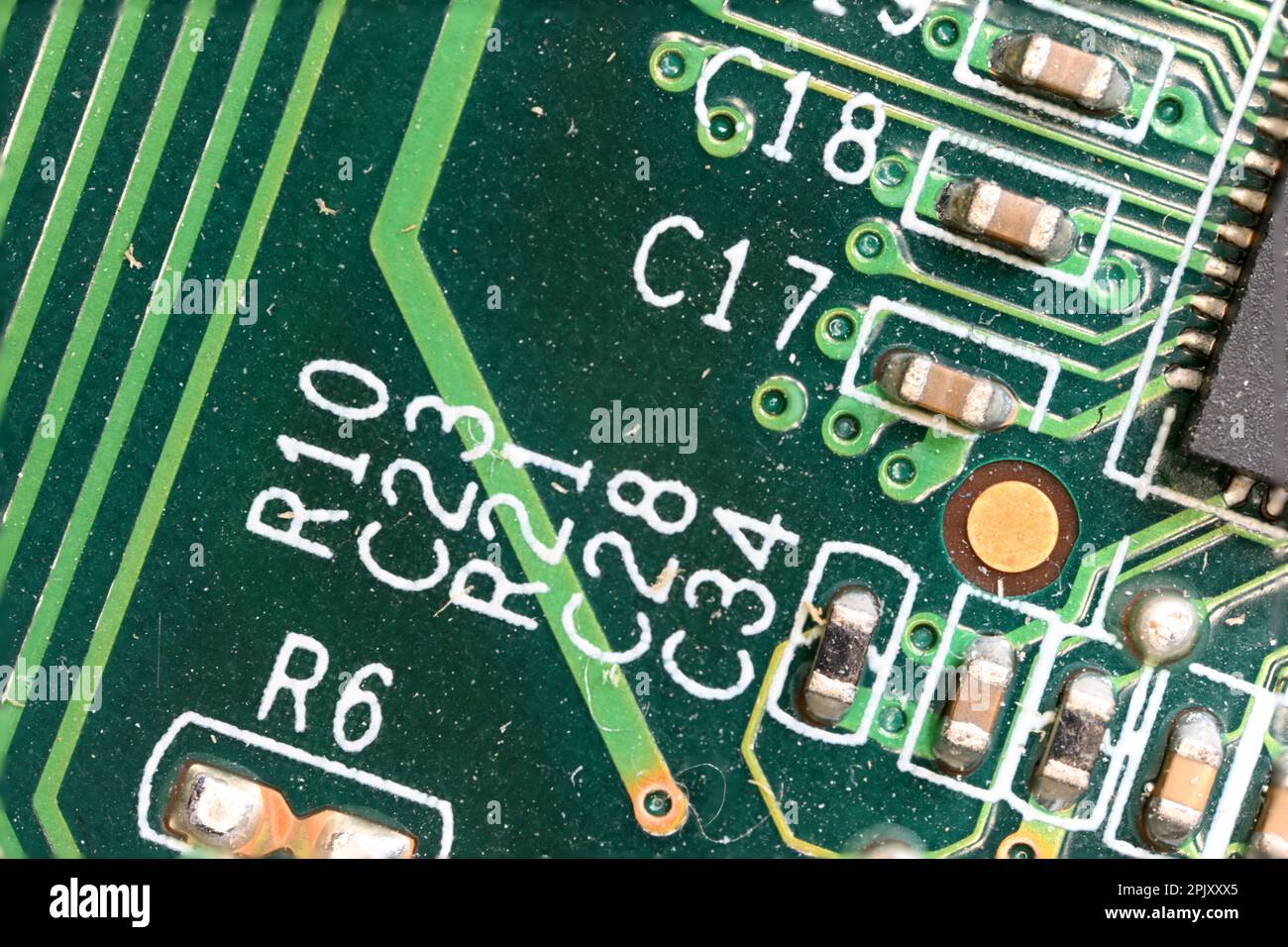 Close-up view of a green computer board with visible traces solder ...