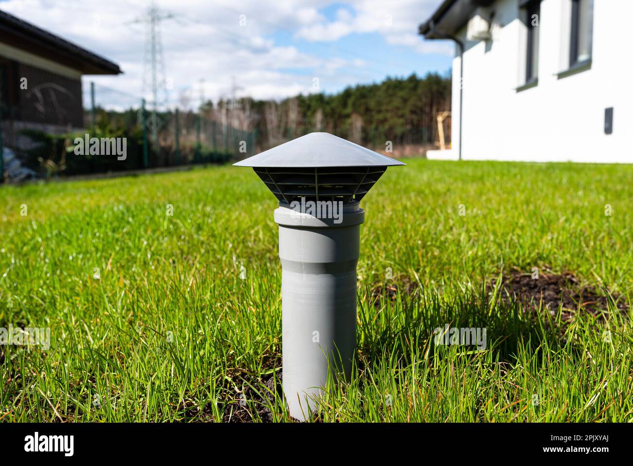 A gray vent pipe from a household septic tank without a drain located ...