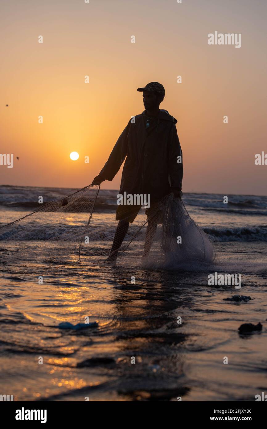 karachi pakistan 2021, a fisherman pulling fishing net to catch fish ...