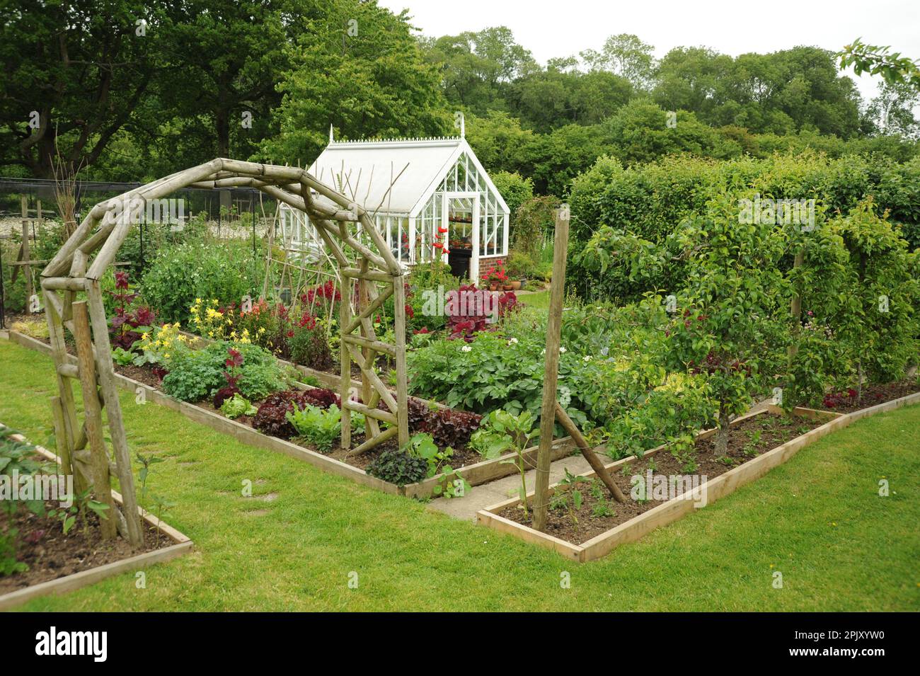 Garden arch and greenhouse Stock Photo - Alamy