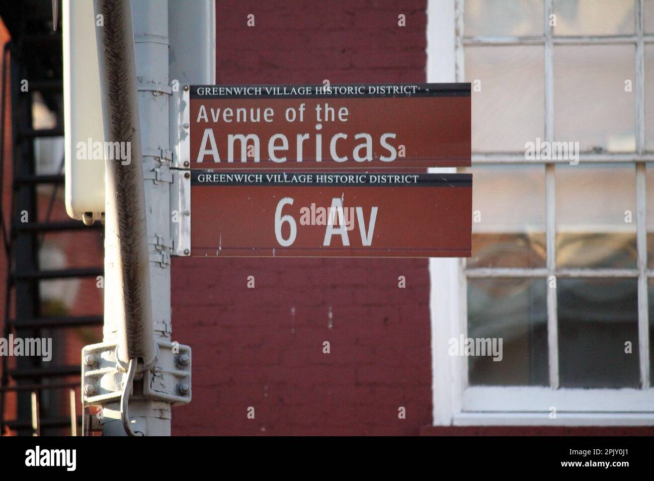 6th Av of the Americas brown traffic sign in New York Stock Photo - Alamy