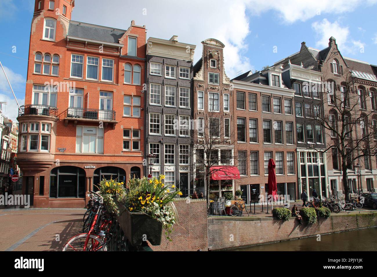 canal and old brick houses and flat buildings in amsterdam (the ...
