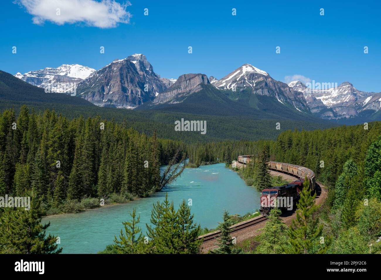 Freight train makes its way through Morants Curve in Banff National Park in the Canadian Rockies ...