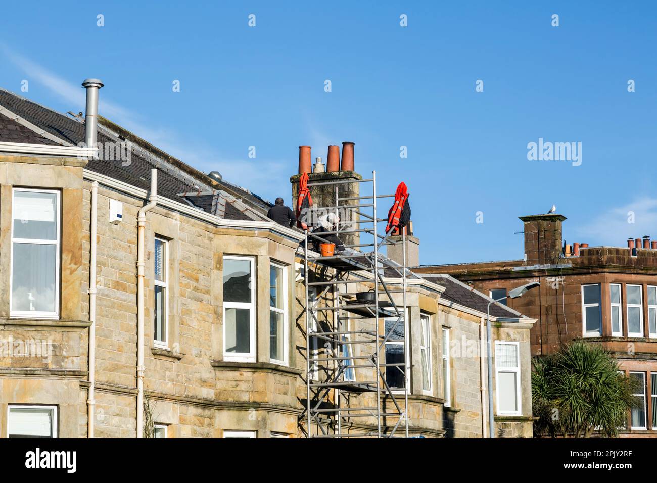 Builders repairing a roof on a terraced house, Scotland, UK, Europe ...