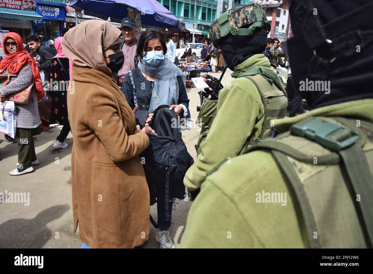 Srinagar, India. 04th Apr, 2023. A female CRPF trooper checks the identity card of a College ...