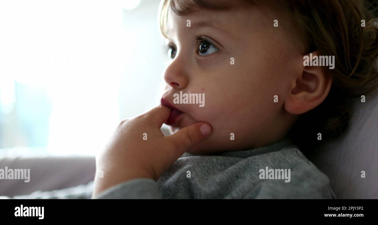 Toddler child face hypnotized by screen off-camera Stock Photo - Alamy