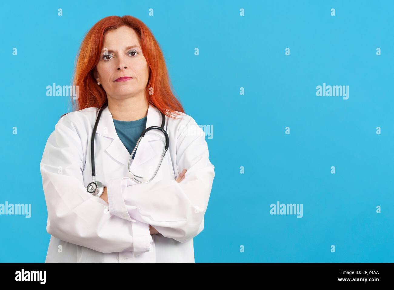 Serious redheaded female doctor arms hi-res stock photography and ...
