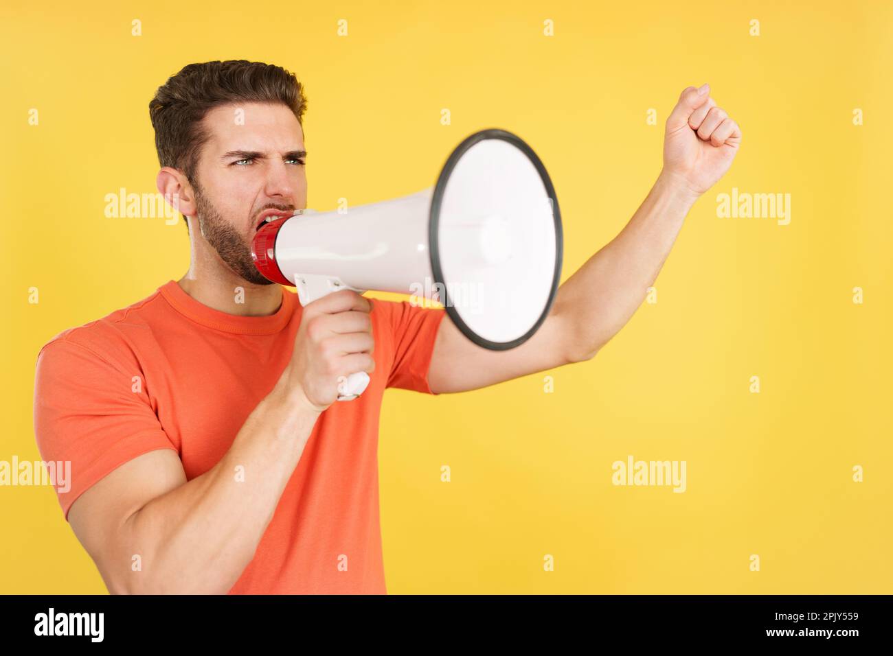 Angry caucasian man shouting using a loudspeaker Stock Photo - Alamy