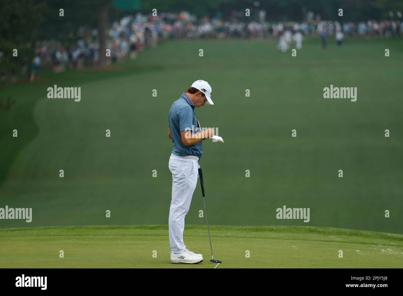 Matt Fitzpatrick, of England, takes notes on the seventh hole during a ...