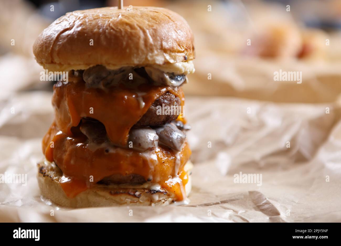 Huge double cheese burger for lunch. Unhealthy and fat hamburger with ...