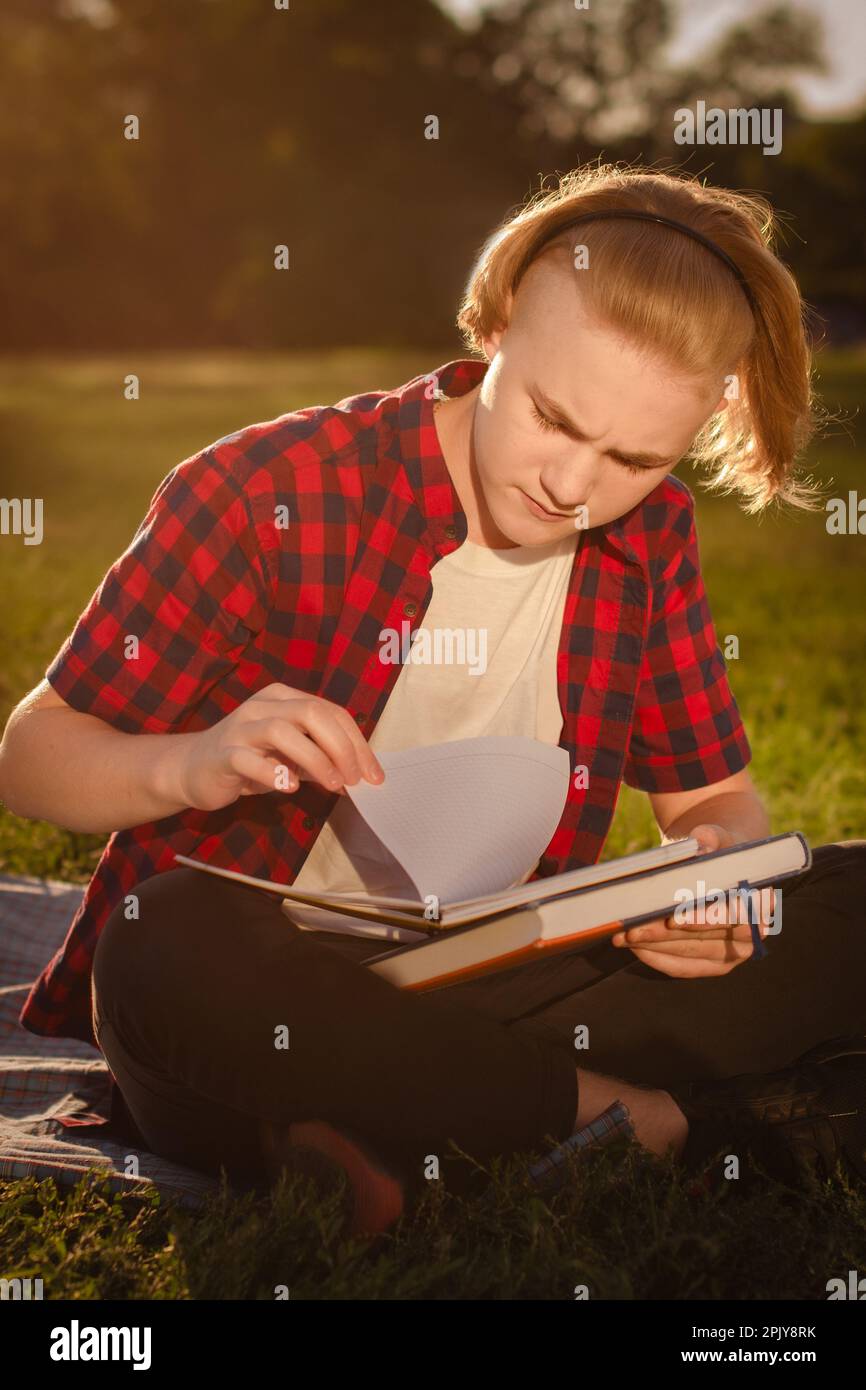 student boy study up in green park alone, study outdoors in university ...