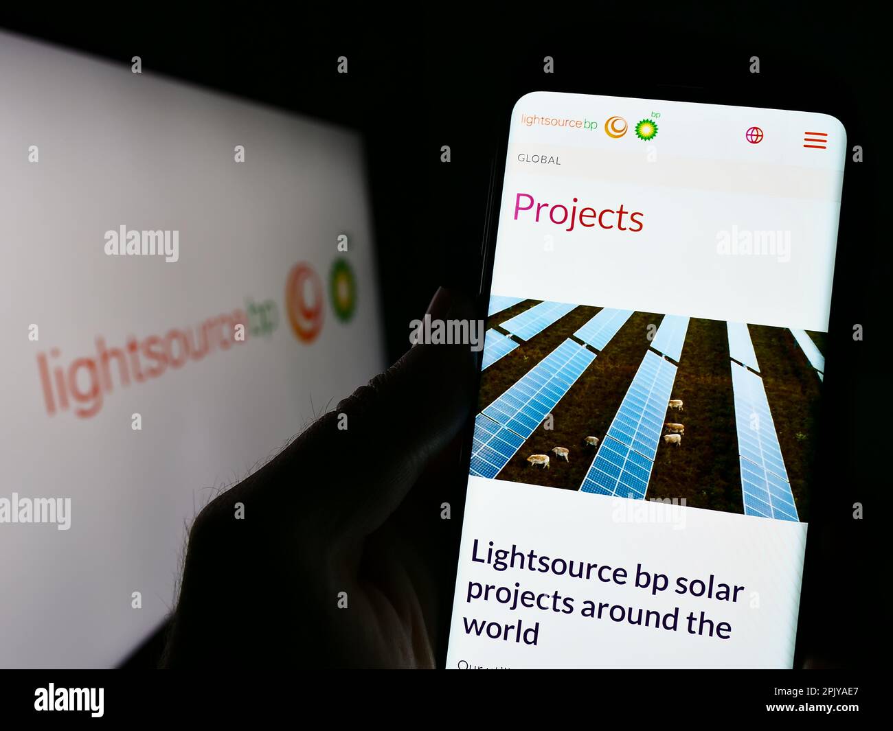 Person holding smartphone with web page of British renewable energy ...