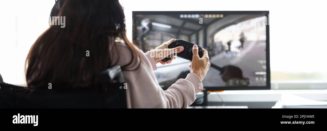Playing computer game in wheelchair hi-res stock photography and images ...