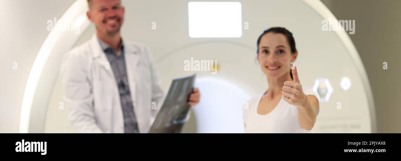 Smiling female patient showing thumbs up gesture at mri procedure Stock ...
