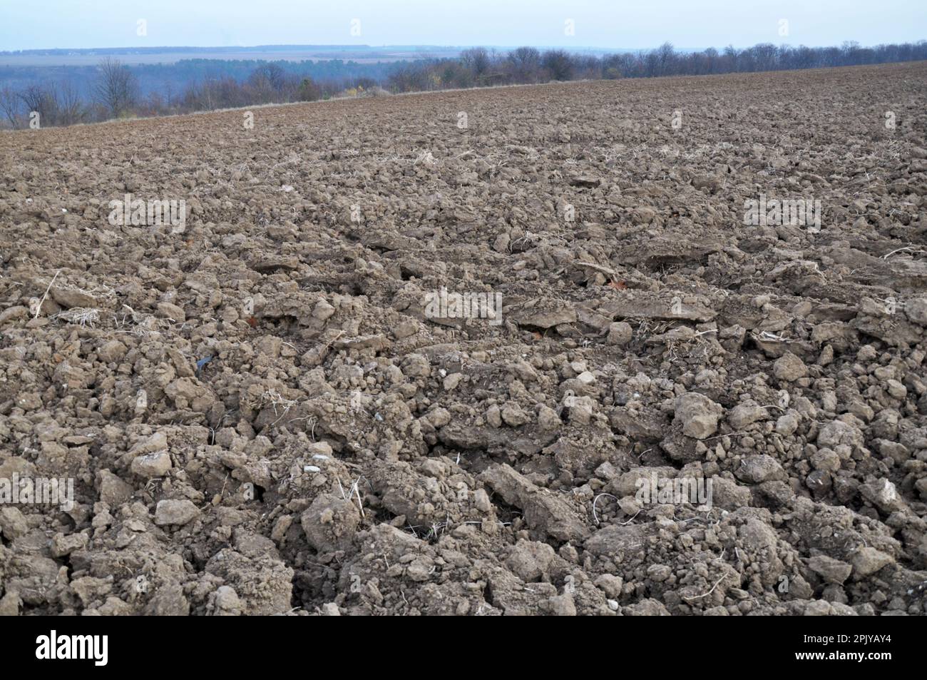 Plowing plow in autumn field with boulders of the earth Stock Photo - Alamy