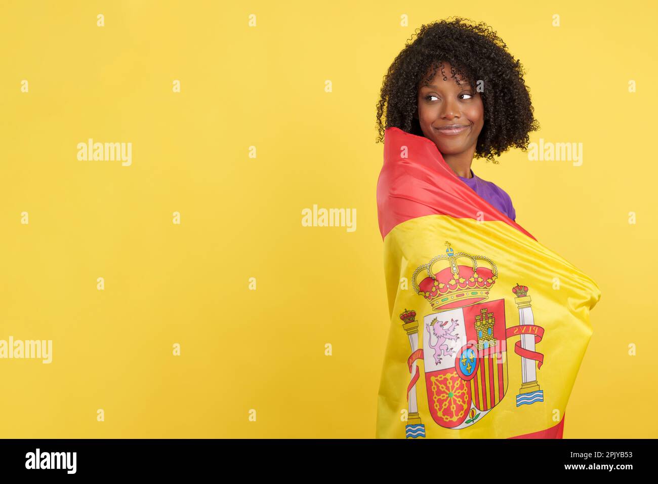 Distracted migrant afro woman wrapped with a Spanish flag Stock Photo ...