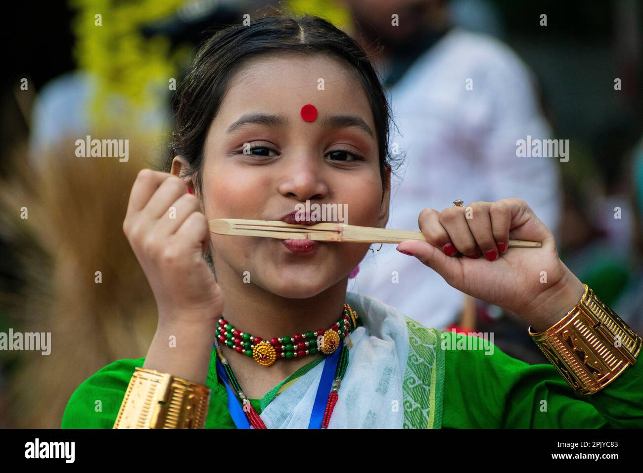 Assam, India. 04/04/2023, Girl playing traditional Gagan instrument as ...