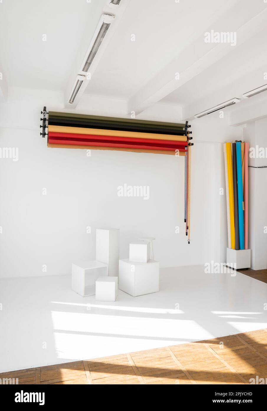 Sunny daylight photo studio interior with set rolls of color background ...