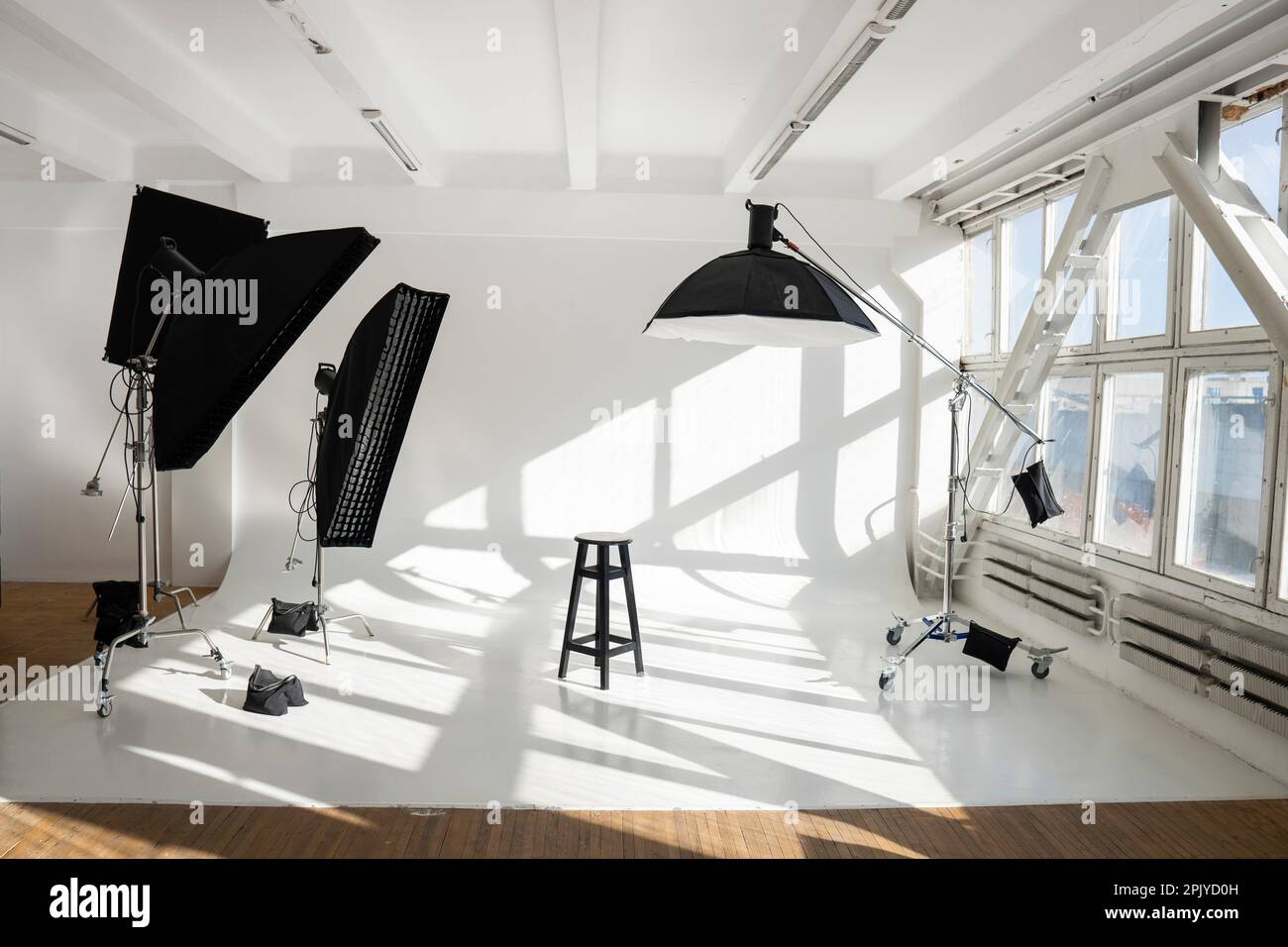 Professional lighting equipment, flashes, c-stands on a cyclorama in ...