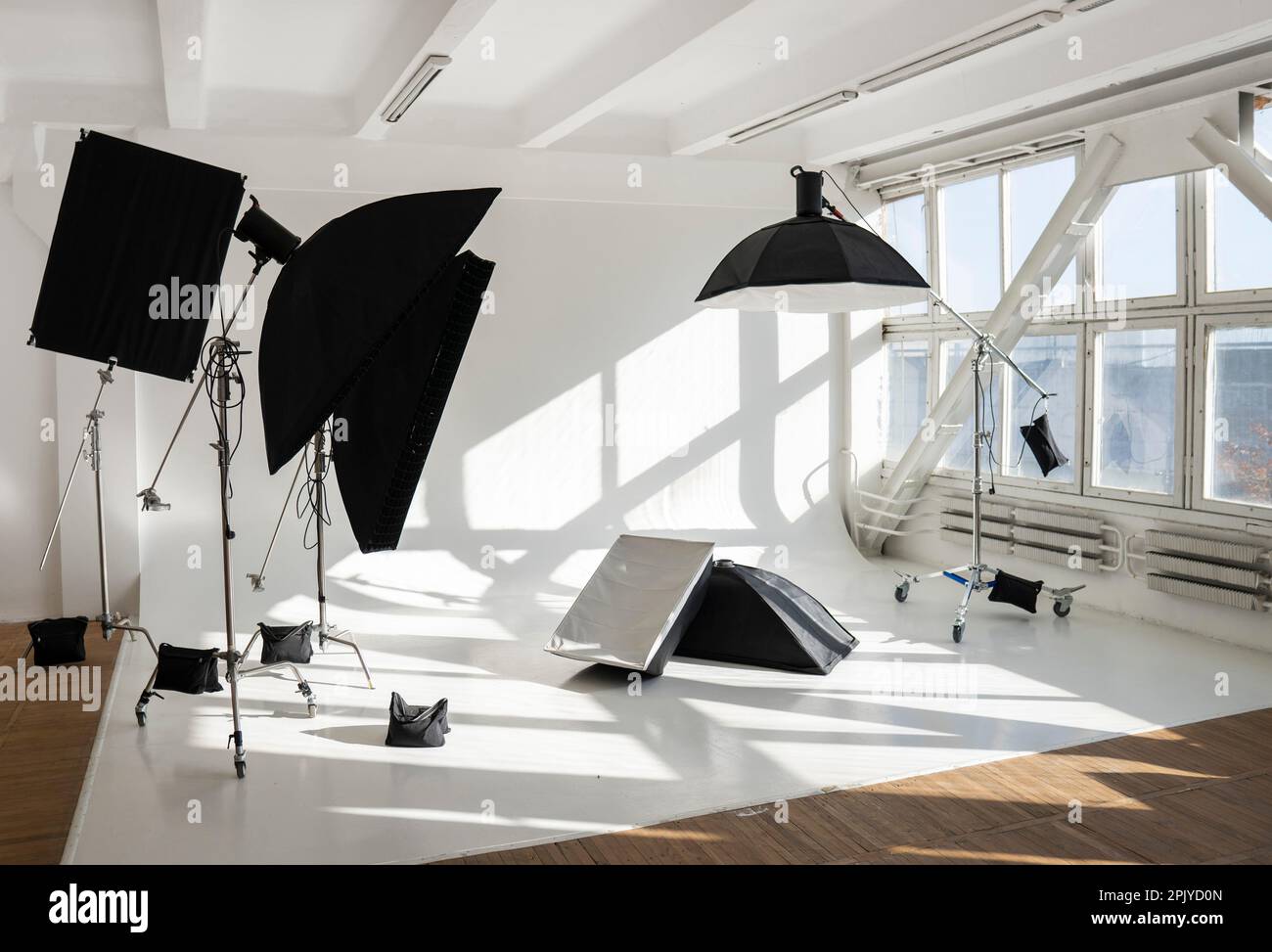 Professional lighting equipment, flashes, c-stands on a cyclorama in ...