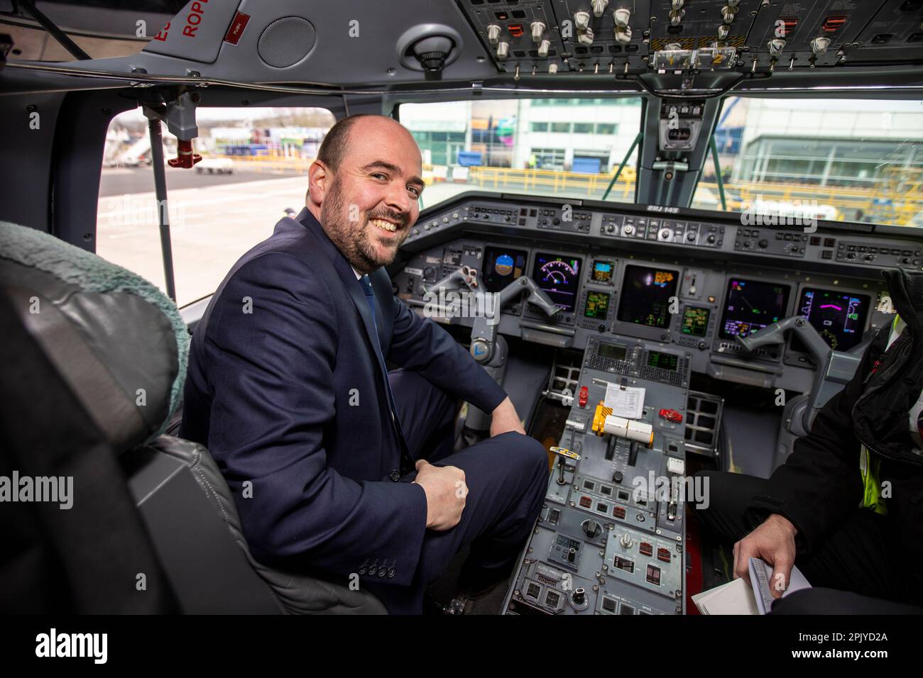 Transport Minister Richard Holden sitting in the captain's seat of the ...