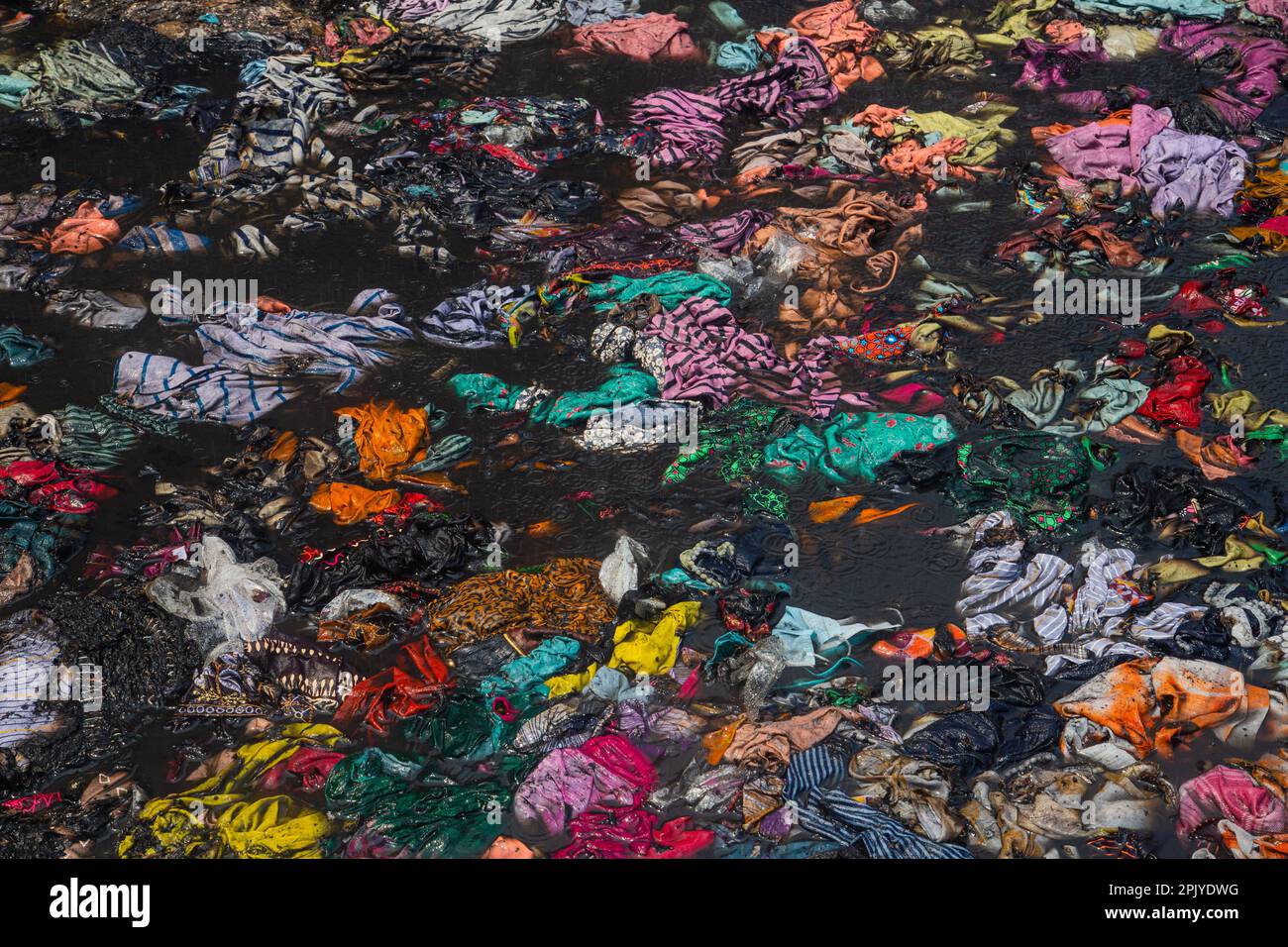 Many freshly burnt clothes are seen floating in the fire service pump ...