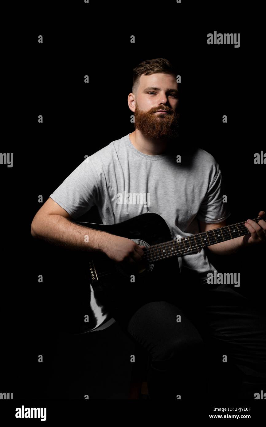 Portrait of young bearded handsome guitarist, artist, composer, pop ...