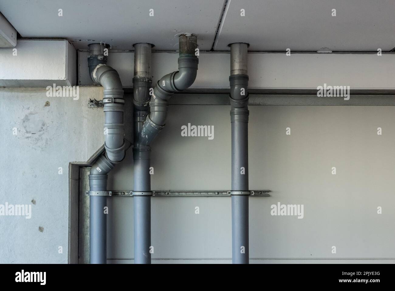 Drain pipes coming down through the roof from an above floor Stock ...