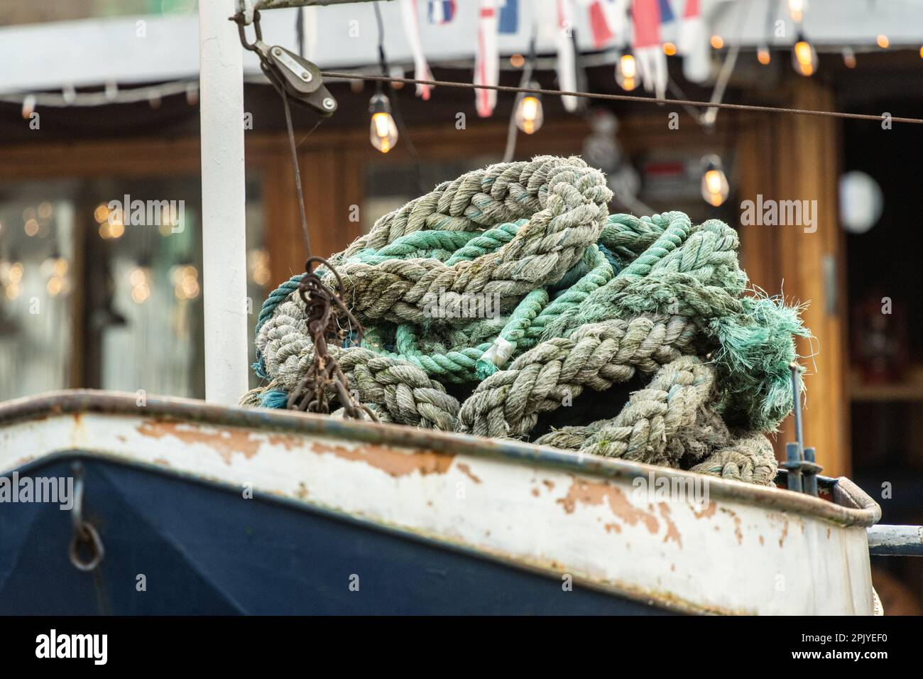 Pile of thick mooring ropes in a small boat Stock Photo - Alamy