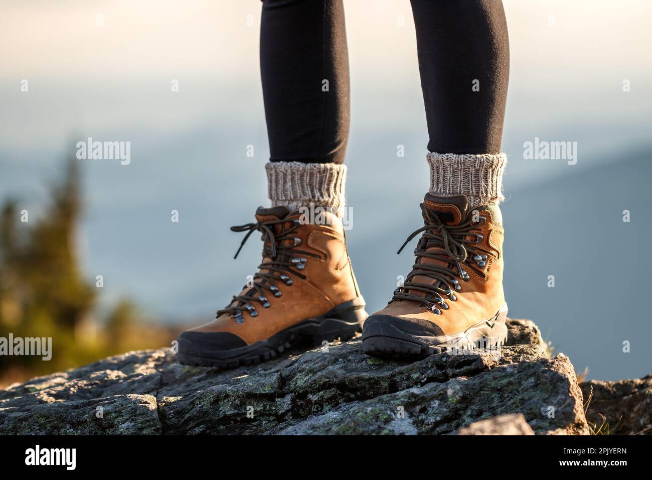 Hiking boot. Female legs on mountain summit during trekking outdoors ...