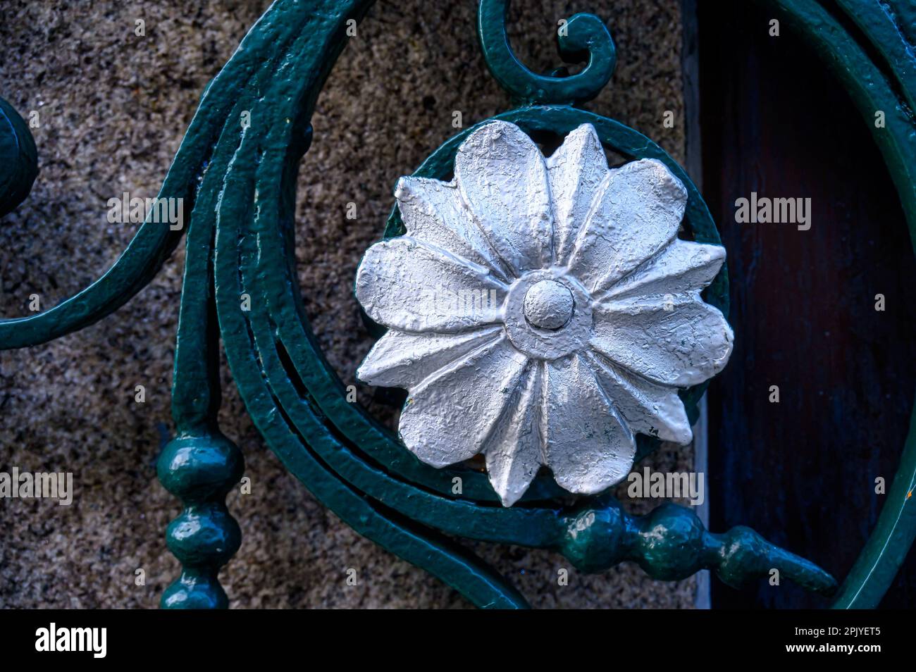 Metal flower shape decorating the surrounding fence. Also known as the ...