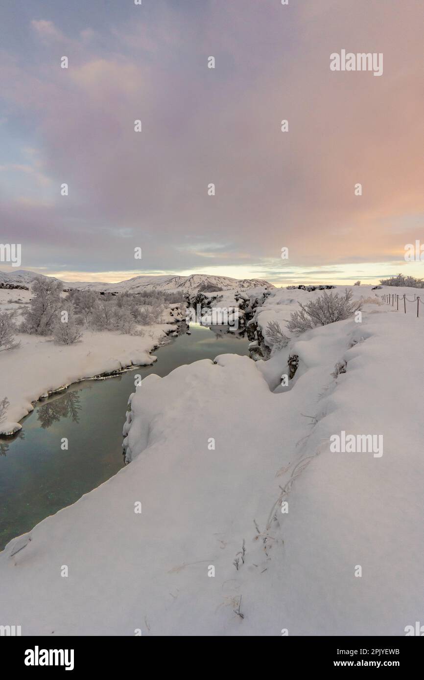 Landscape, mountain and snowy trees and river reflecting the sky of ...