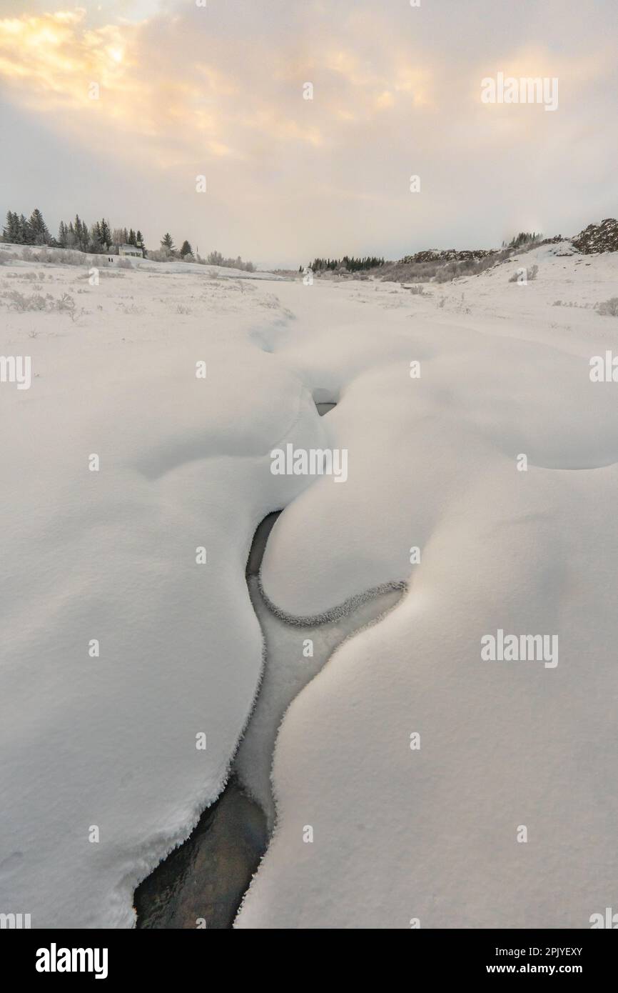 Landscape, mountain and snowy trees and river reflecting the sky of ...