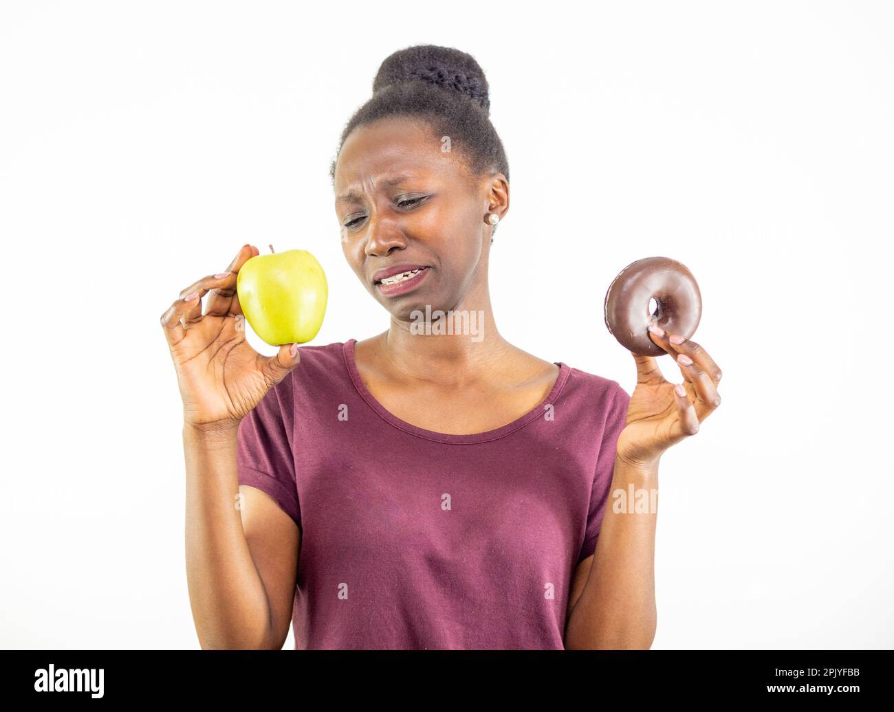 Young Woman Choosing Between Healthy Food And Junk Food Isolated On