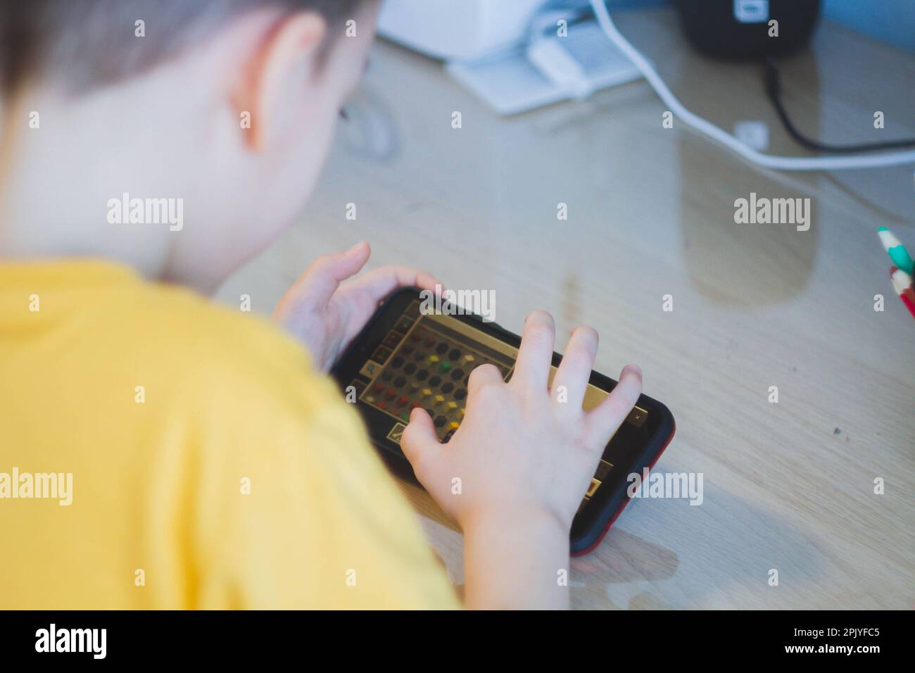Phone in hands of child. Little boy playing mobile games on smartphone ...