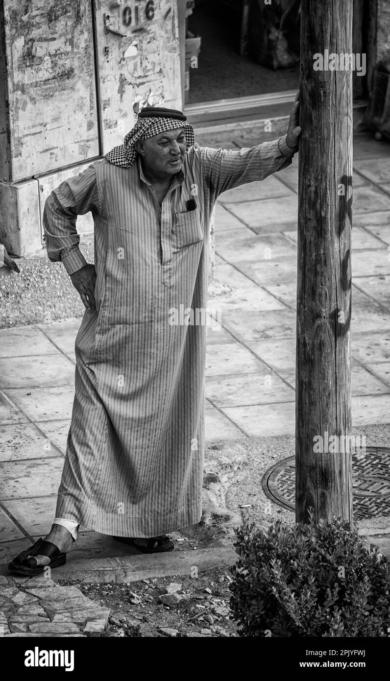 A street portrait of a man standing on a sidewalk of Amman. Jordon ...