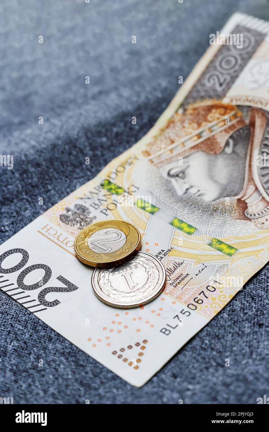 Two Polish coins and a banknote on a gray, material background Stock ...