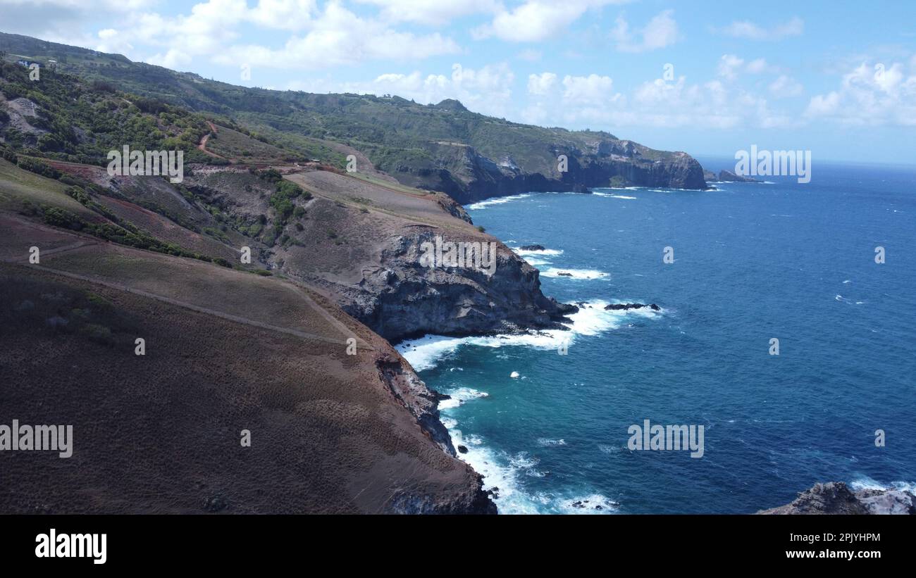 Aerial view of a stunning ocean landscape featuring a grassy hillside ...