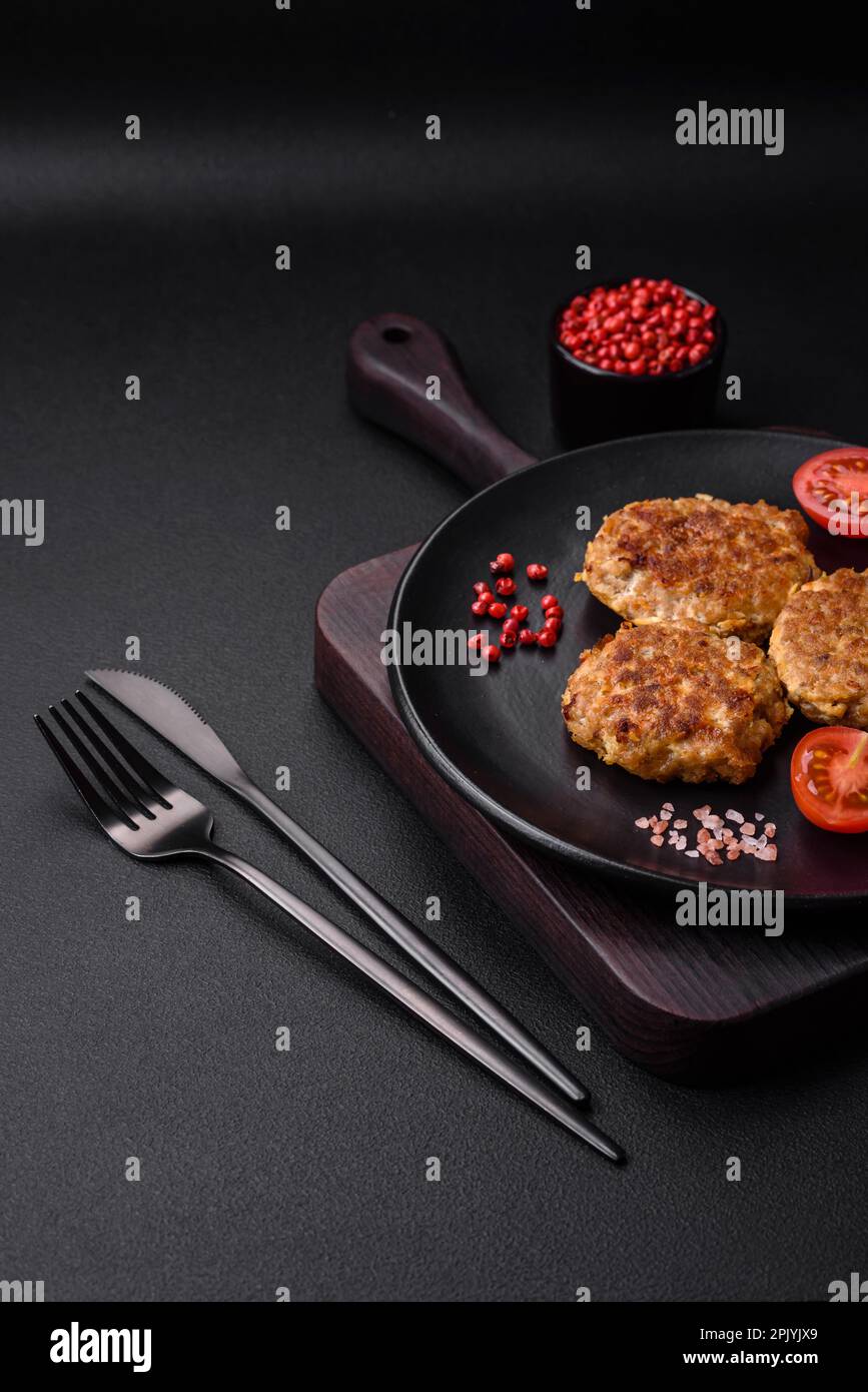 Delicious fresh fried minced fish cutlets with spices and herbs on a ...