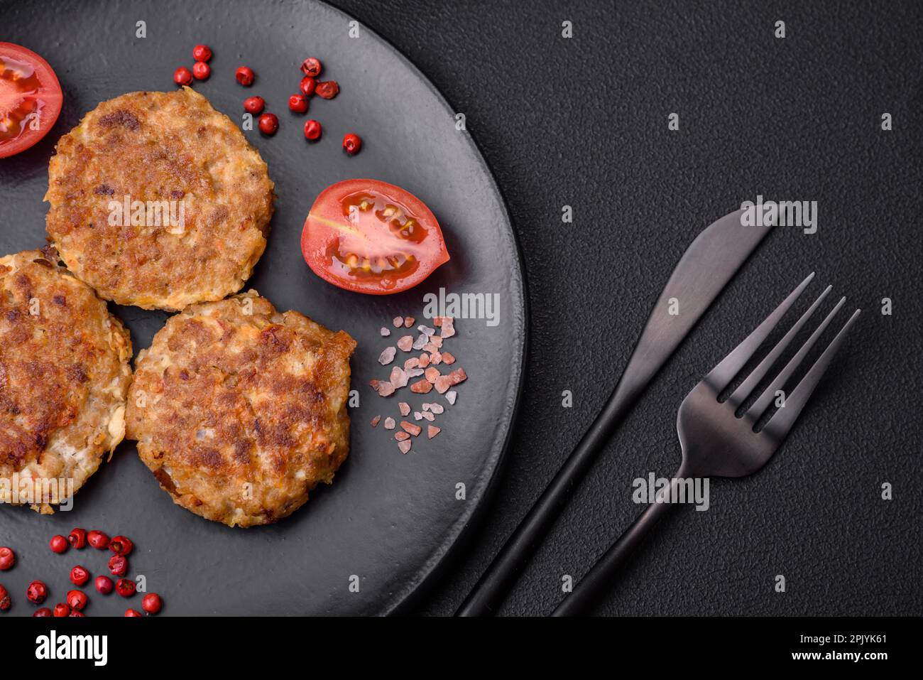 Delicious fresh fried minced fish cutlets with spices and herbs on a ...