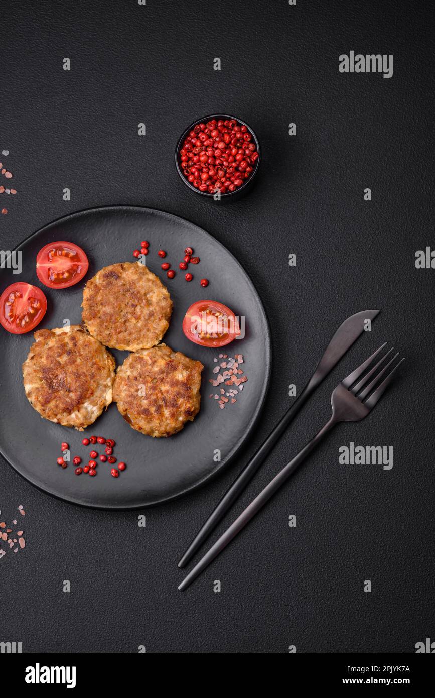 Delicious fresh fried minced fish cutlets with spices and herbs on a ...