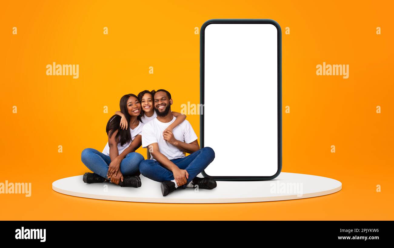 Glad millennial african american man, woman and girl sit on floor, hugs ...