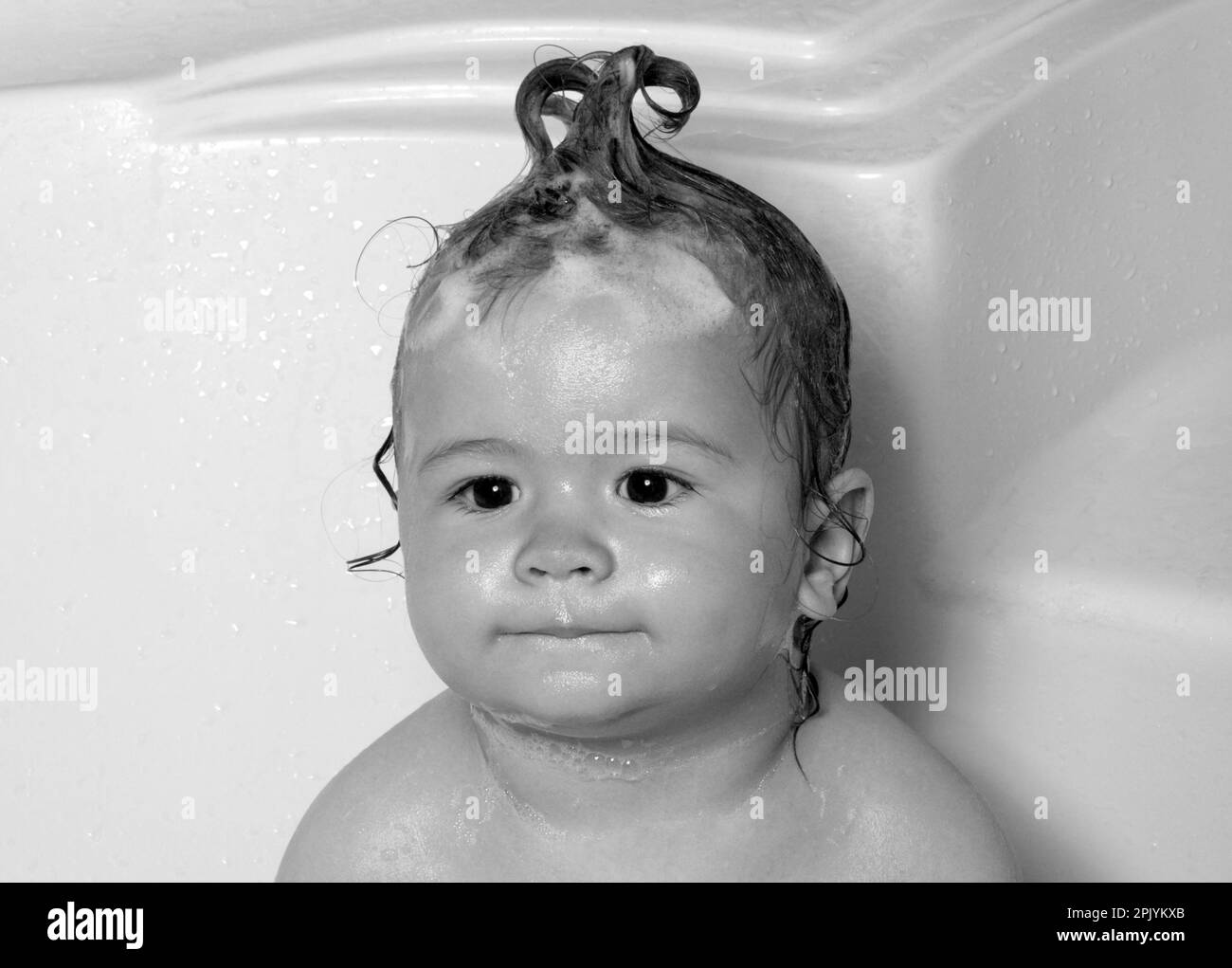 Happy baby face in bubble bath. Baby bathes in a bath with foam and ... Happy baby face in bubble bath. Baby bathes in a bath with foam and ...