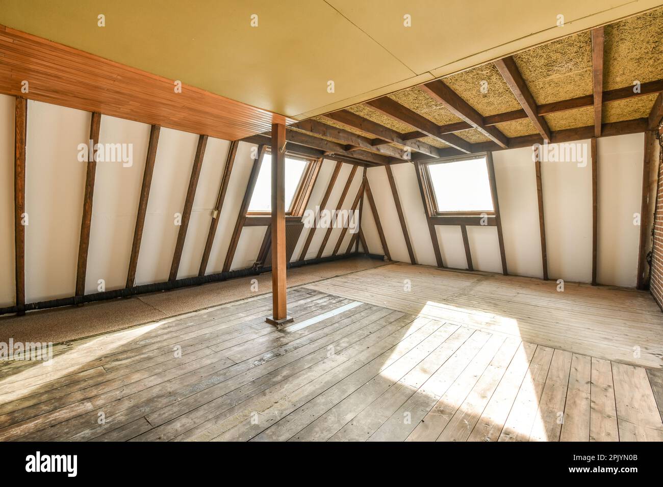 an attic with wood flooring and exposed beams on the ceiling, looking ...