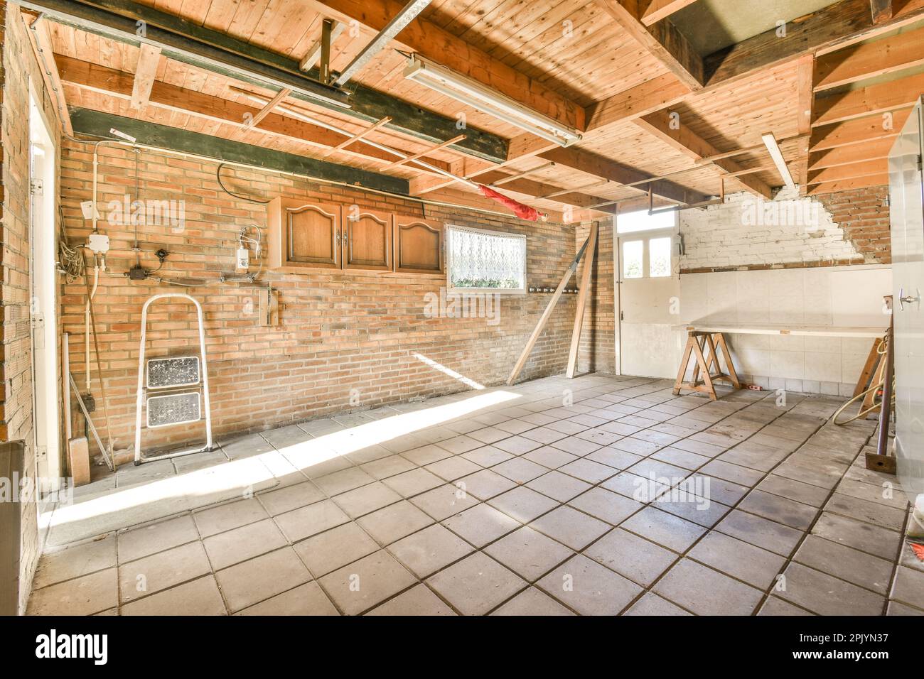 an unfinished room with brick walls and exposed ceilings on the wall is ...