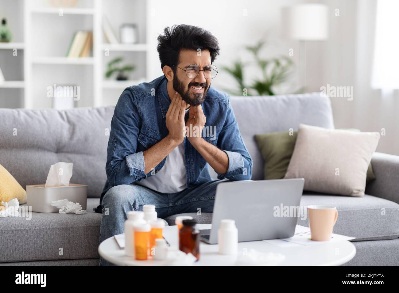 Seasonal Cold And Telemedicine. Sick young indian man suffering from ...