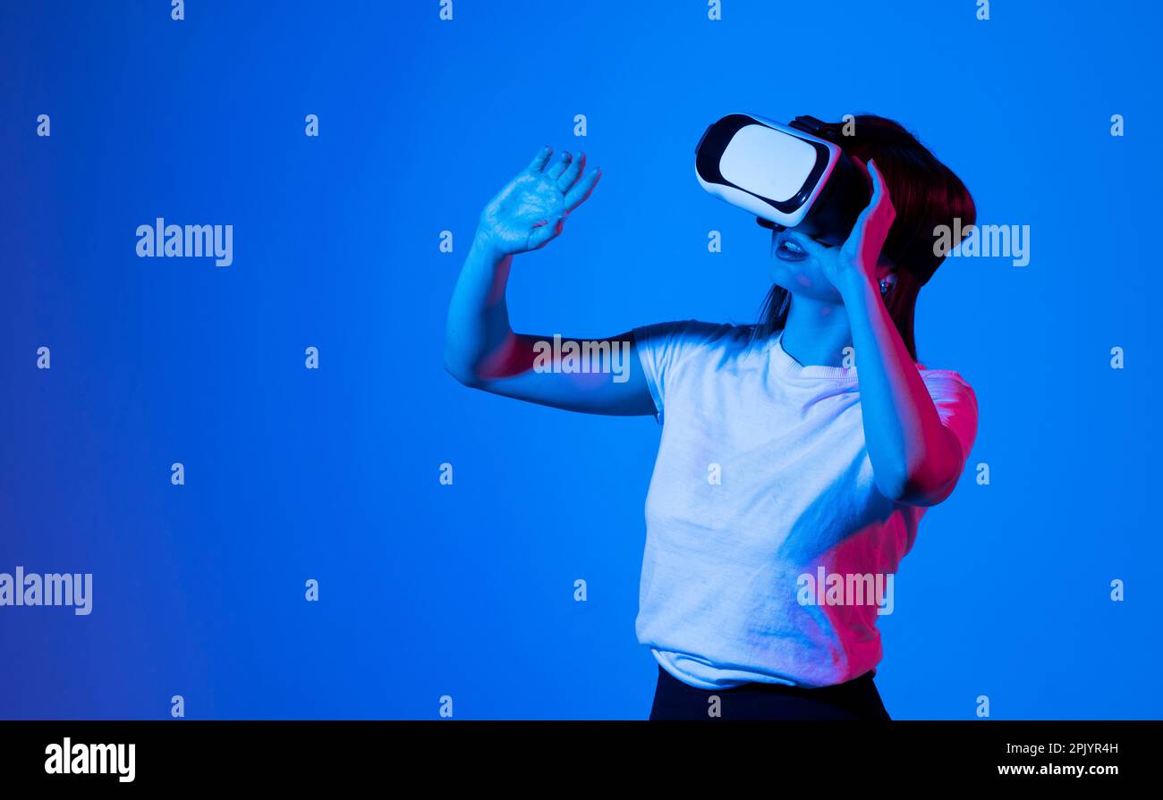 Woman in VR headset using finger to touch on imaginary panel viewing on ...