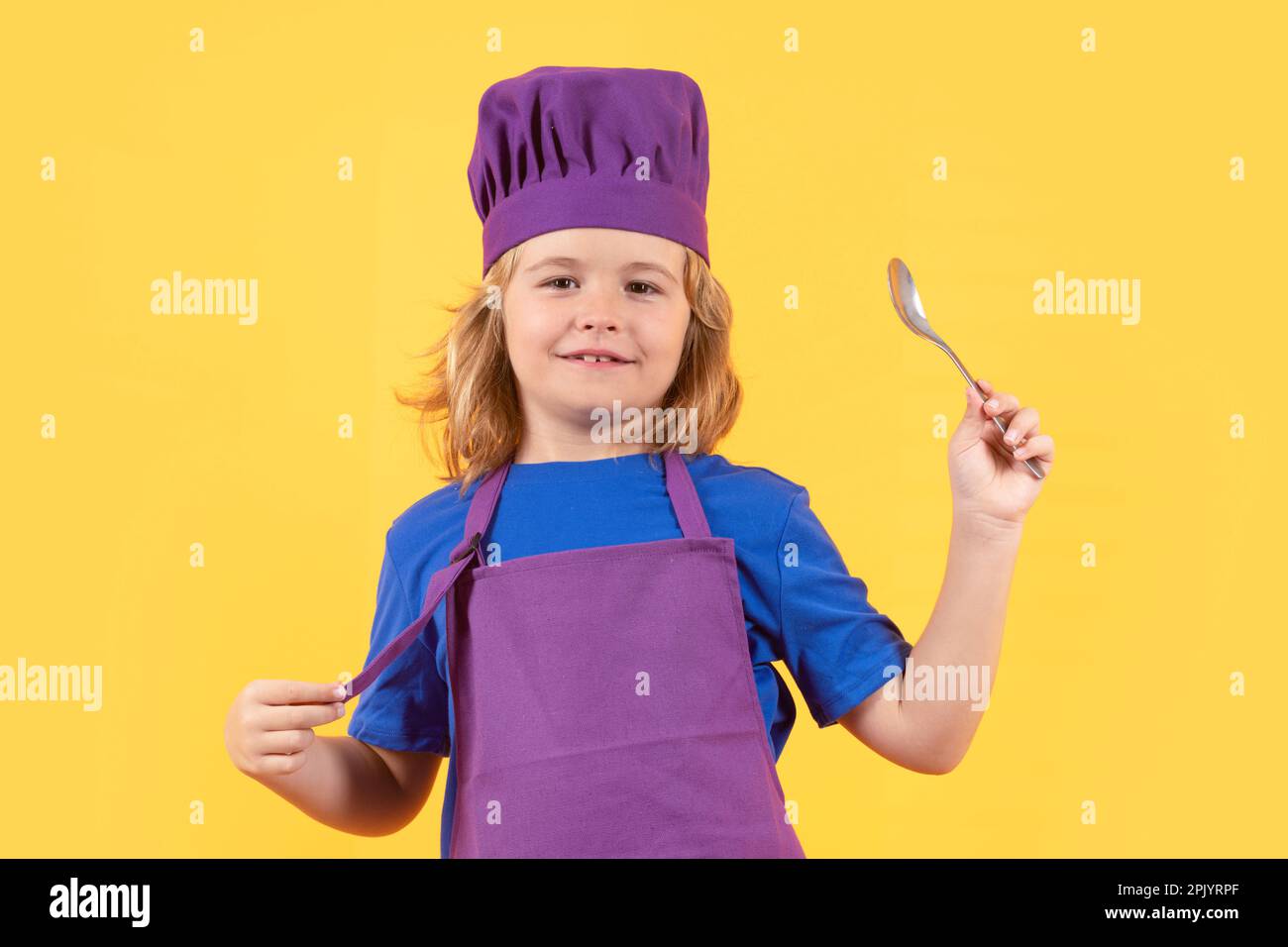Funny kid chef cook with spoon, studio portrait. Kid chef cook prepares ...